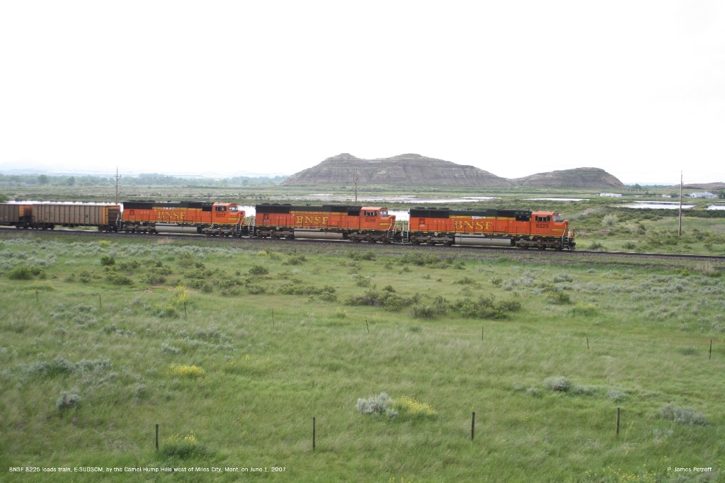 BNSF 8225 leads a set of three SD75M's west by the Camel Hump Hills